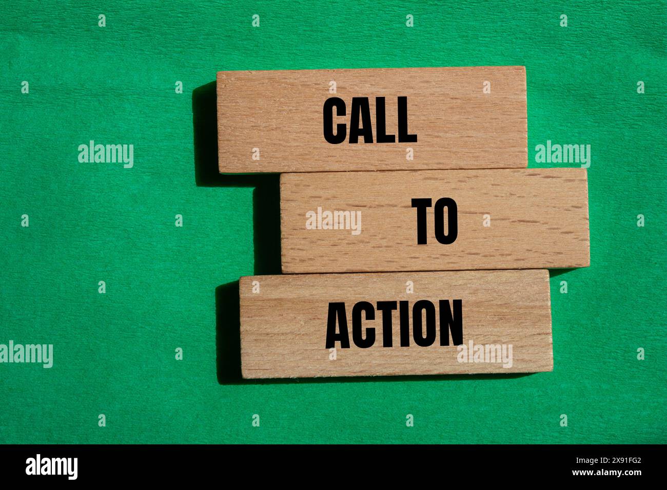 Call to action words written on wooden blocks with green background ...