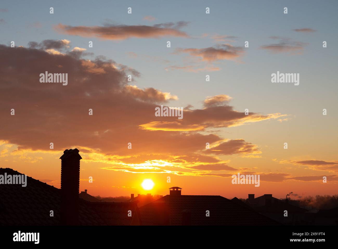Beautiful sky at sunset. Bright orange clouds in the rays of the ...
