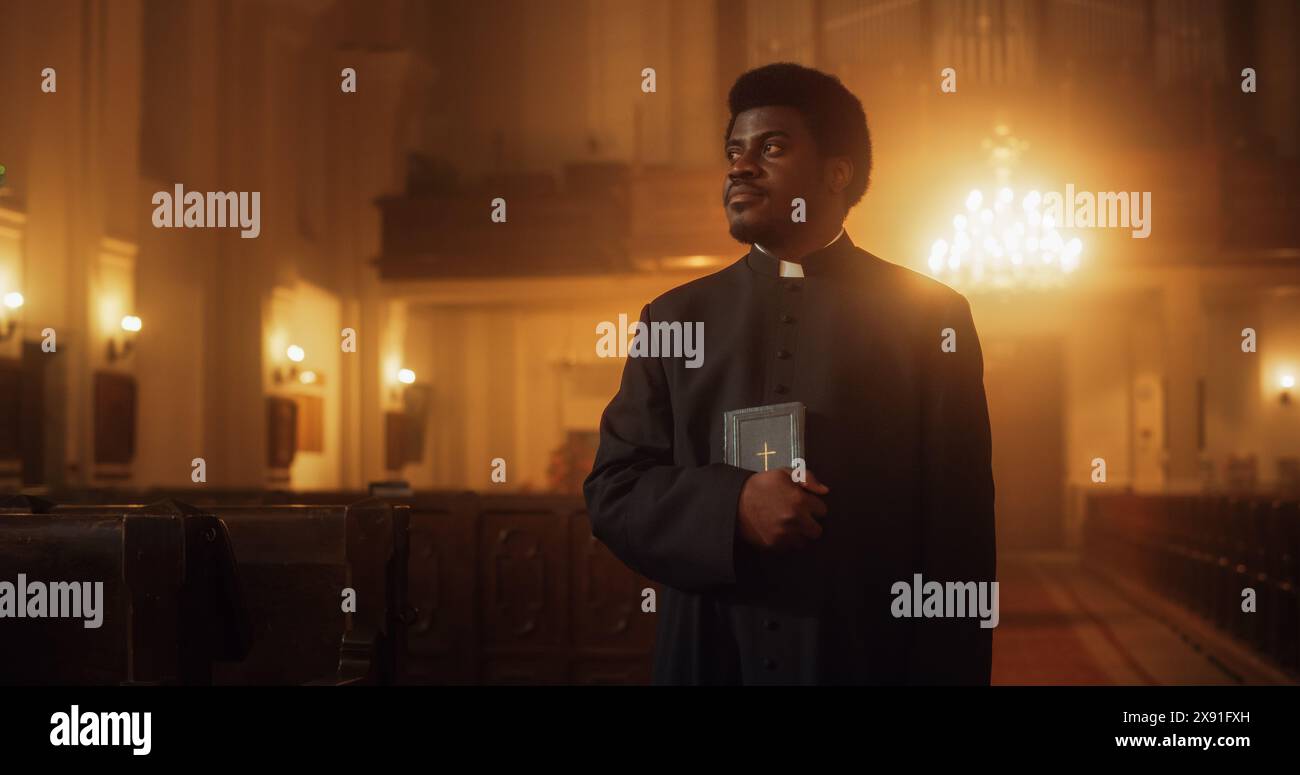 Portrait of a Young Black Priest Holding the Holy Bible in His Hand. A ...