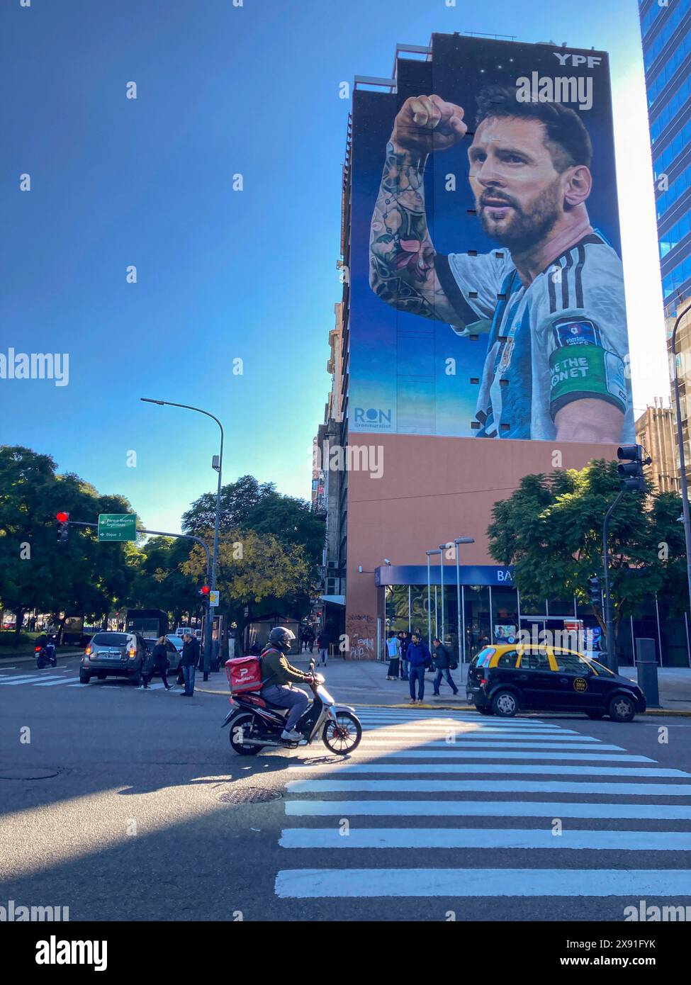 Street scene with giant mural showing Lionel Messi in winning pose ...