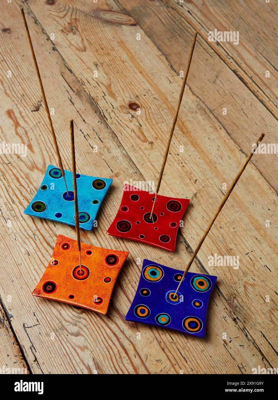 Four different colour ceramic incense holders Stock Photo - Alamy