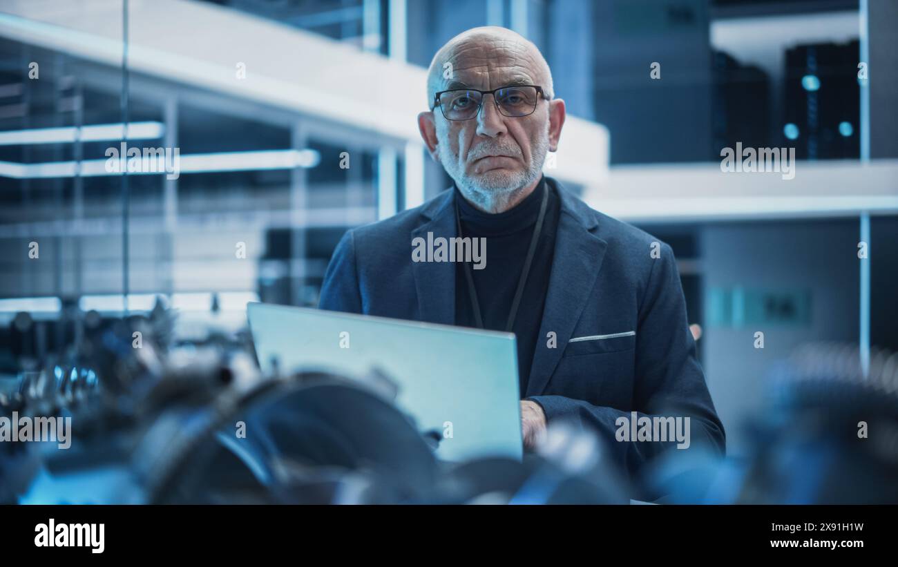 Portrait of a Senior Chief Engineer Using Laptop Computer, Analyzing ...