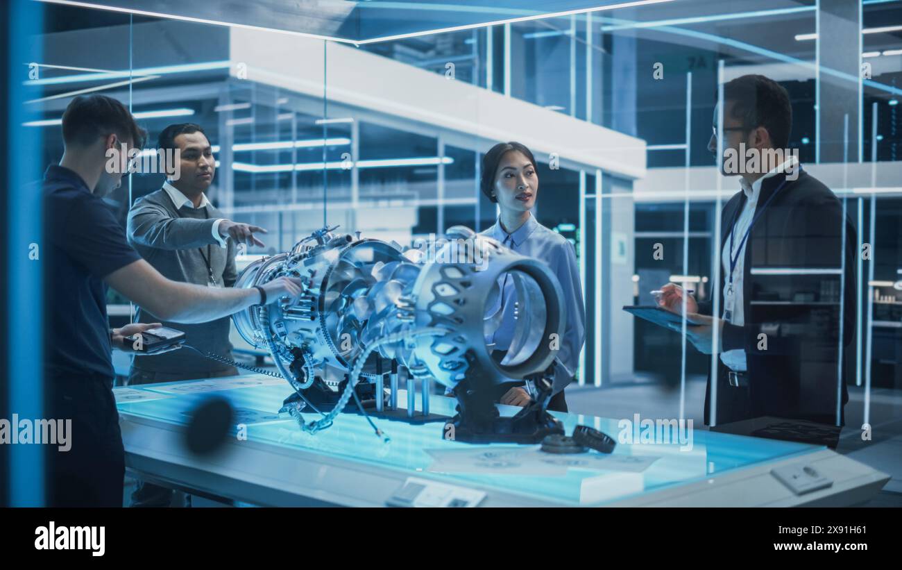 Young Team of Multicultural Engineers Use Blueprints, Tablet and Laptop ...