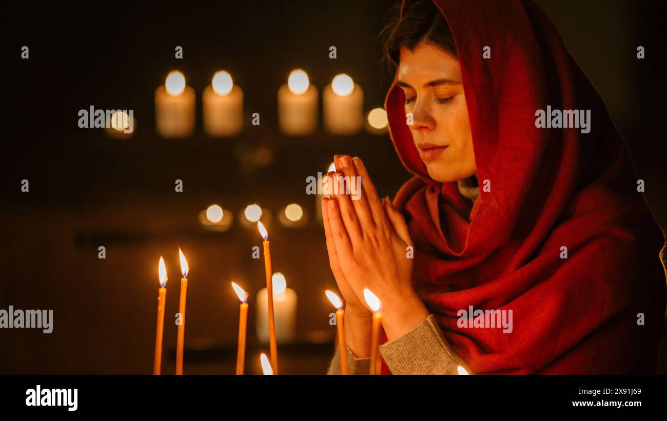 Devout Christian Woman with Head Scarf Lighting a Candle in Church ...