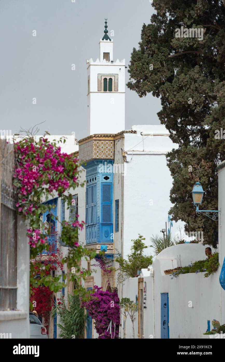Mosque minaret in the narrow street of the beautiful cliff top village ...