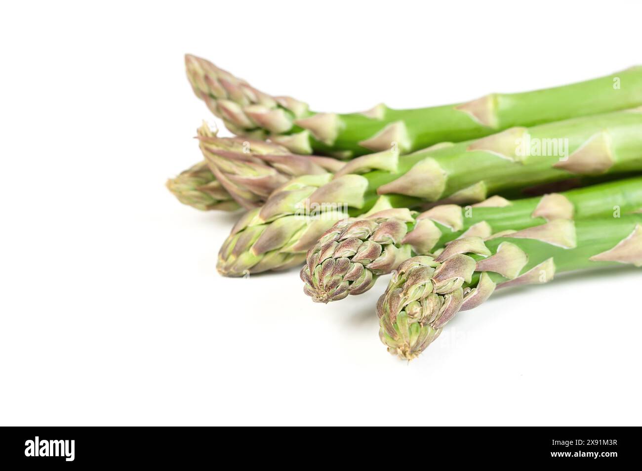 A close-up view of several fresh green asparagus spears neatly piled on ...