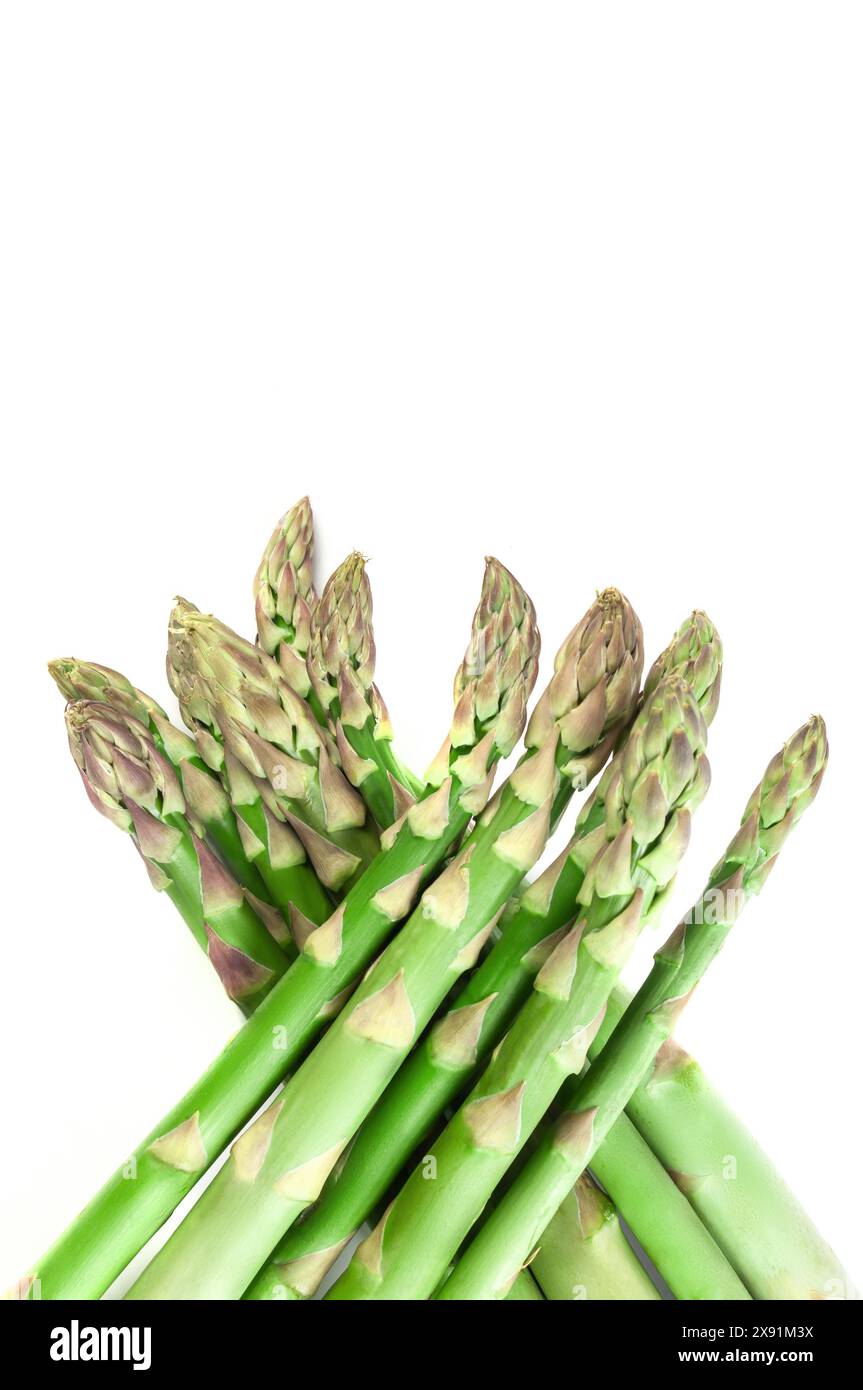 A close-up view of several fresh green asparagus spears neatly piled on ...