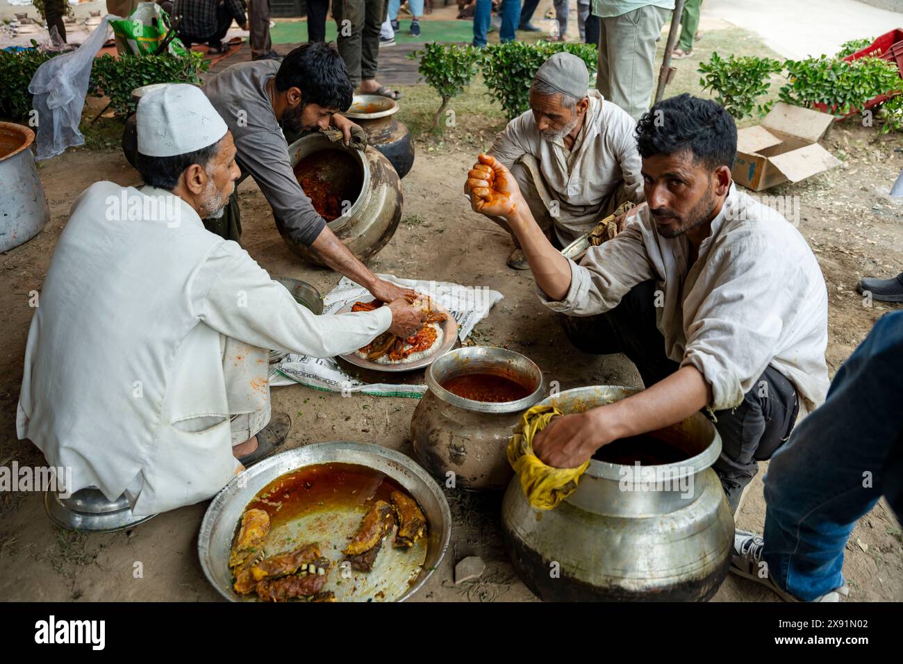 A traditional Kashmiri chef prepares a copper platter (trami) with ...