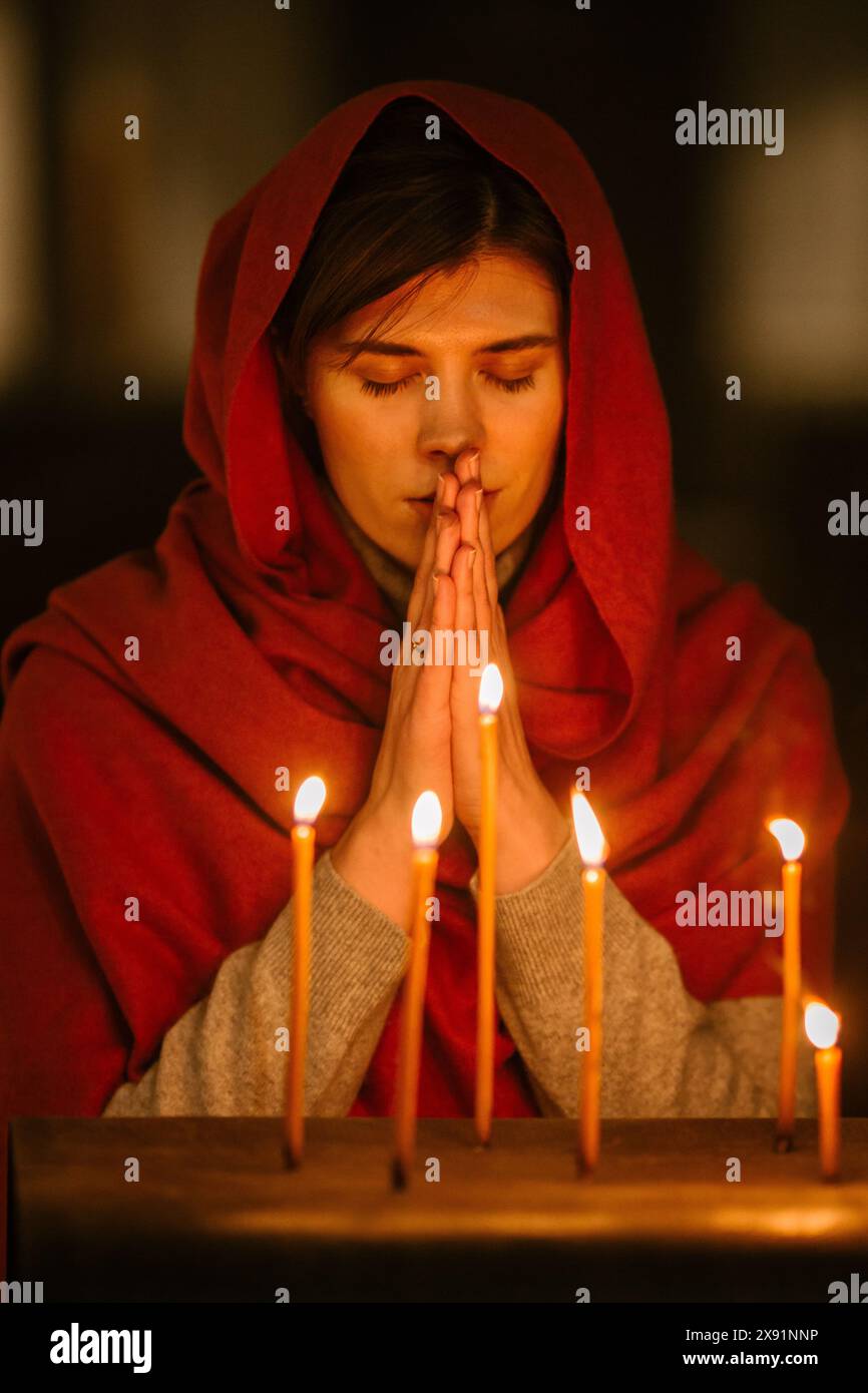 Devout Christian Woman with Head Scarf Lighting a Candle in Church ...
