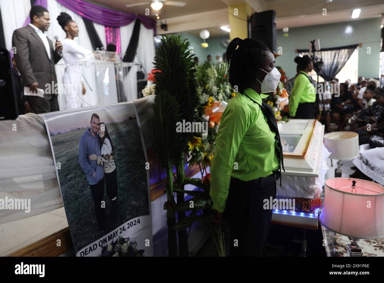A photograph of Davy and Natalie Lloyd hangs during the funeral of ...