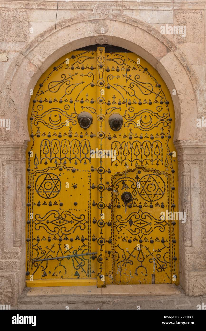 Detailed yellow ornate design of a typical door in the Medina of Tunis ...