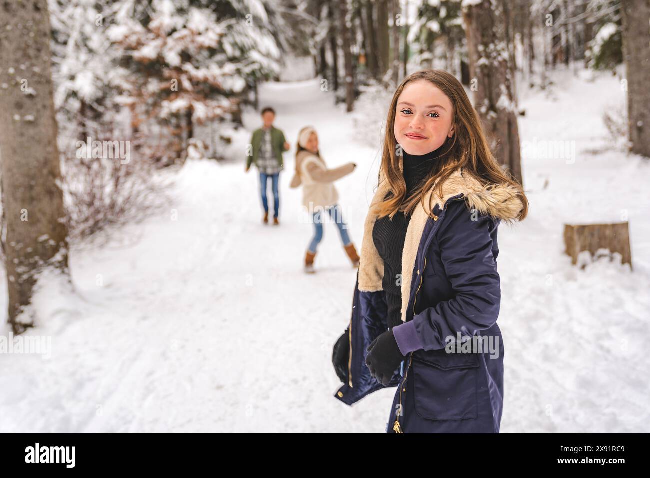 cute Little girl in winter snow forest Stock Photo - Alamy