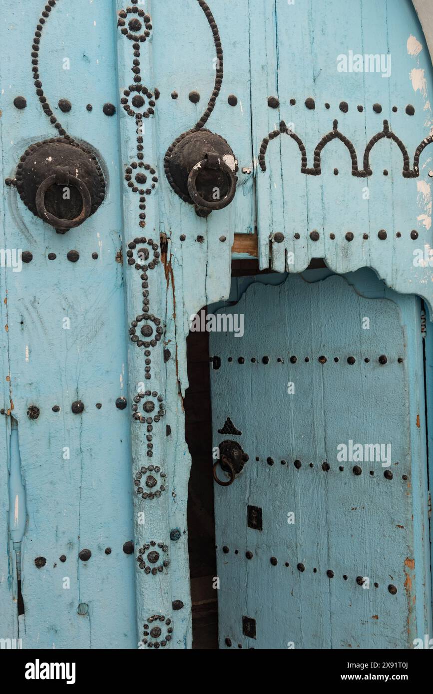 An open old blue wooden door, traditional local architecture in the ...
