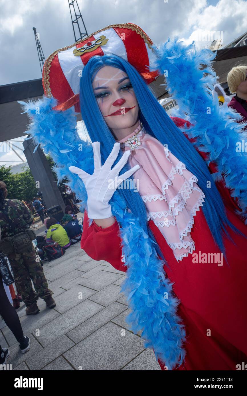 A visitor to the second day of Comic Con London Poses outside the venue ...