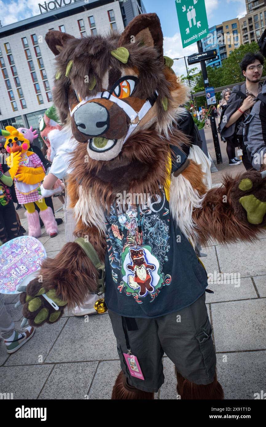 A visitor to the second day of Comic Con London wears a brown furry ...