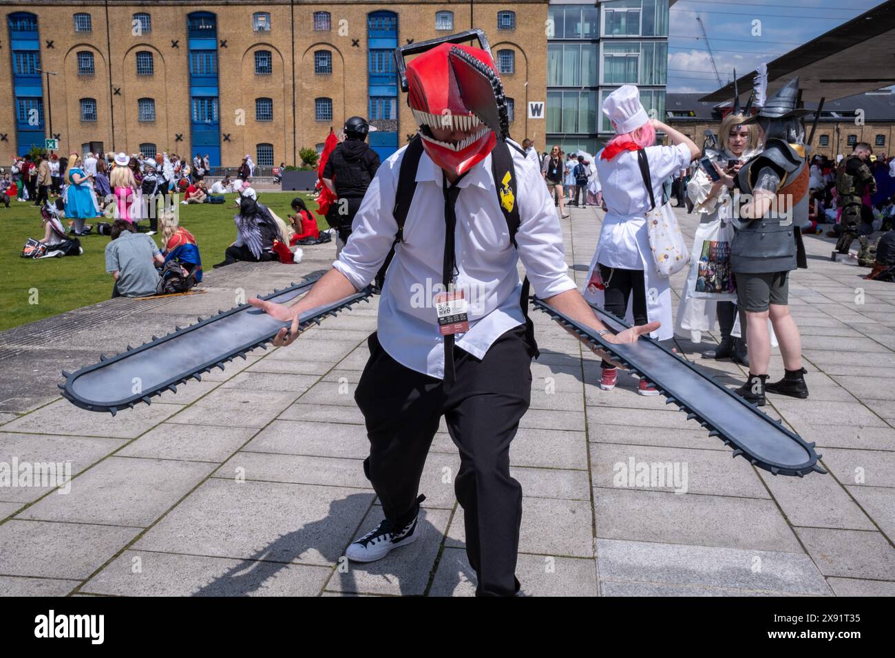 A visitor to day two of Comic Con London poses in a Chainsaw Man ...