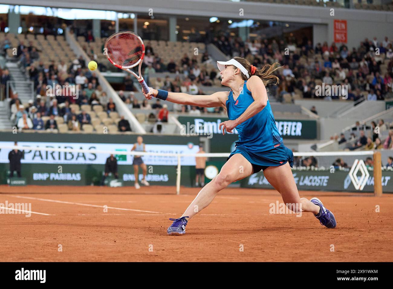 Alize Cornet of France returns a ball against Qinwen Zheng of China in ...