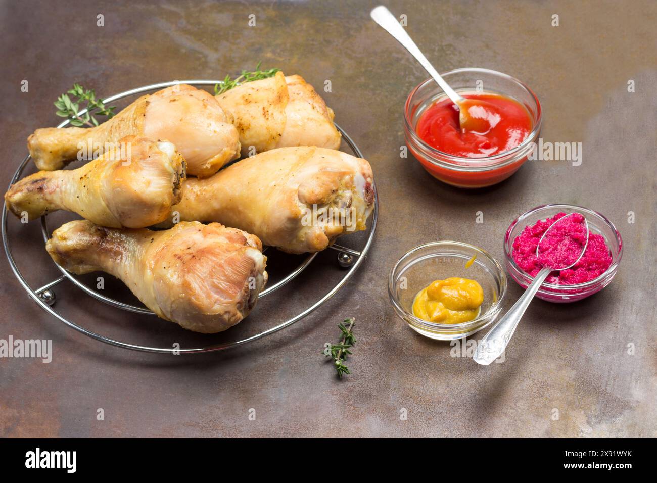 Chicken thighs with tomato paste and mustard. Rusty metal background ...