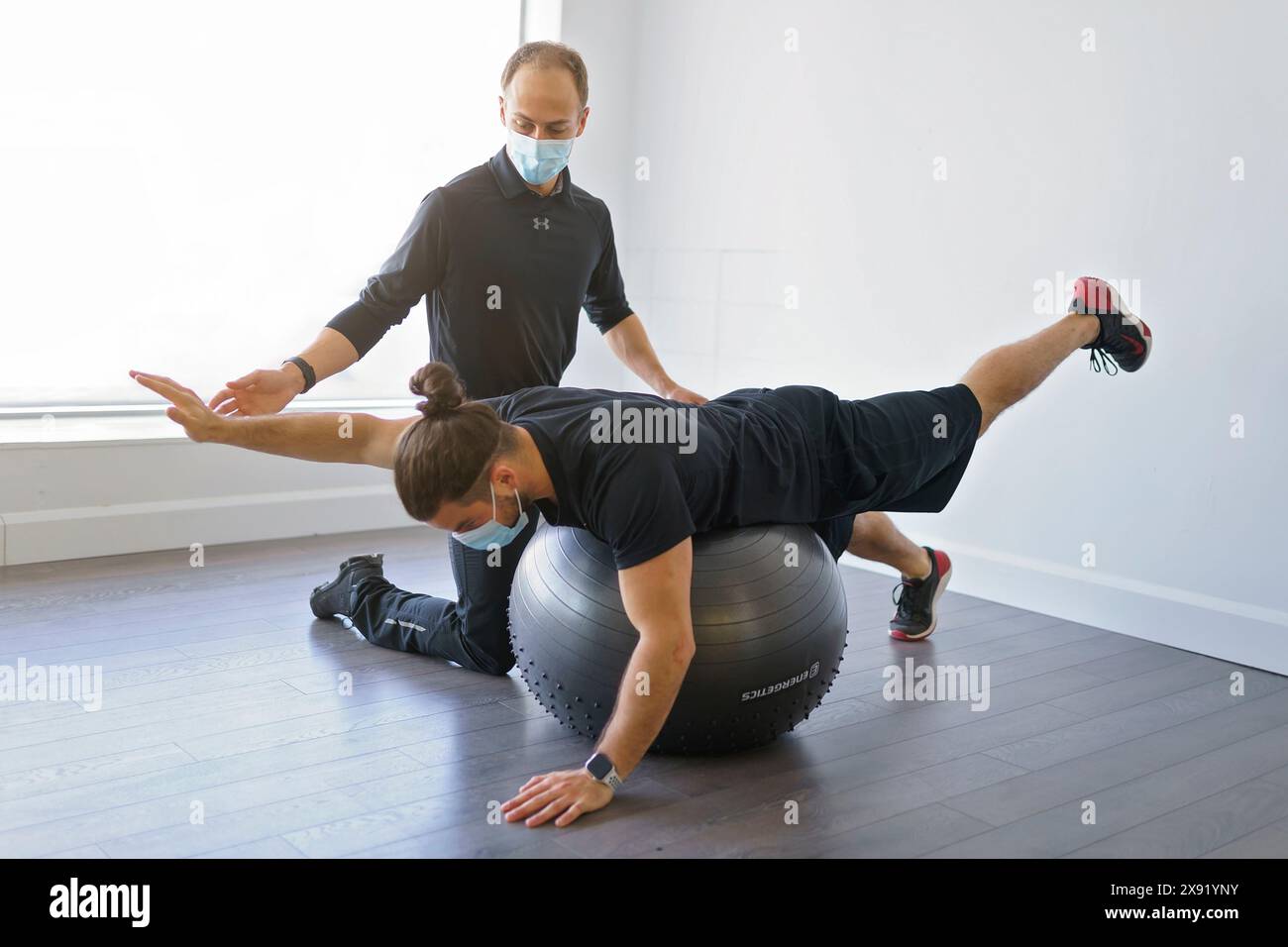 physiotherapist doing therapeutic exercises for patient at the clinic ...