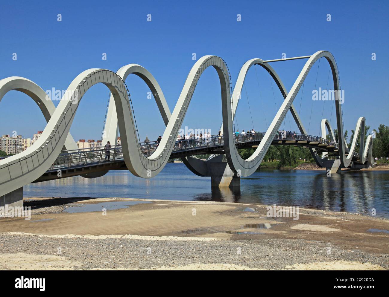 Kiev, Ukraine - May 25, 2024: Modern artistic wave shaped bridge over ...