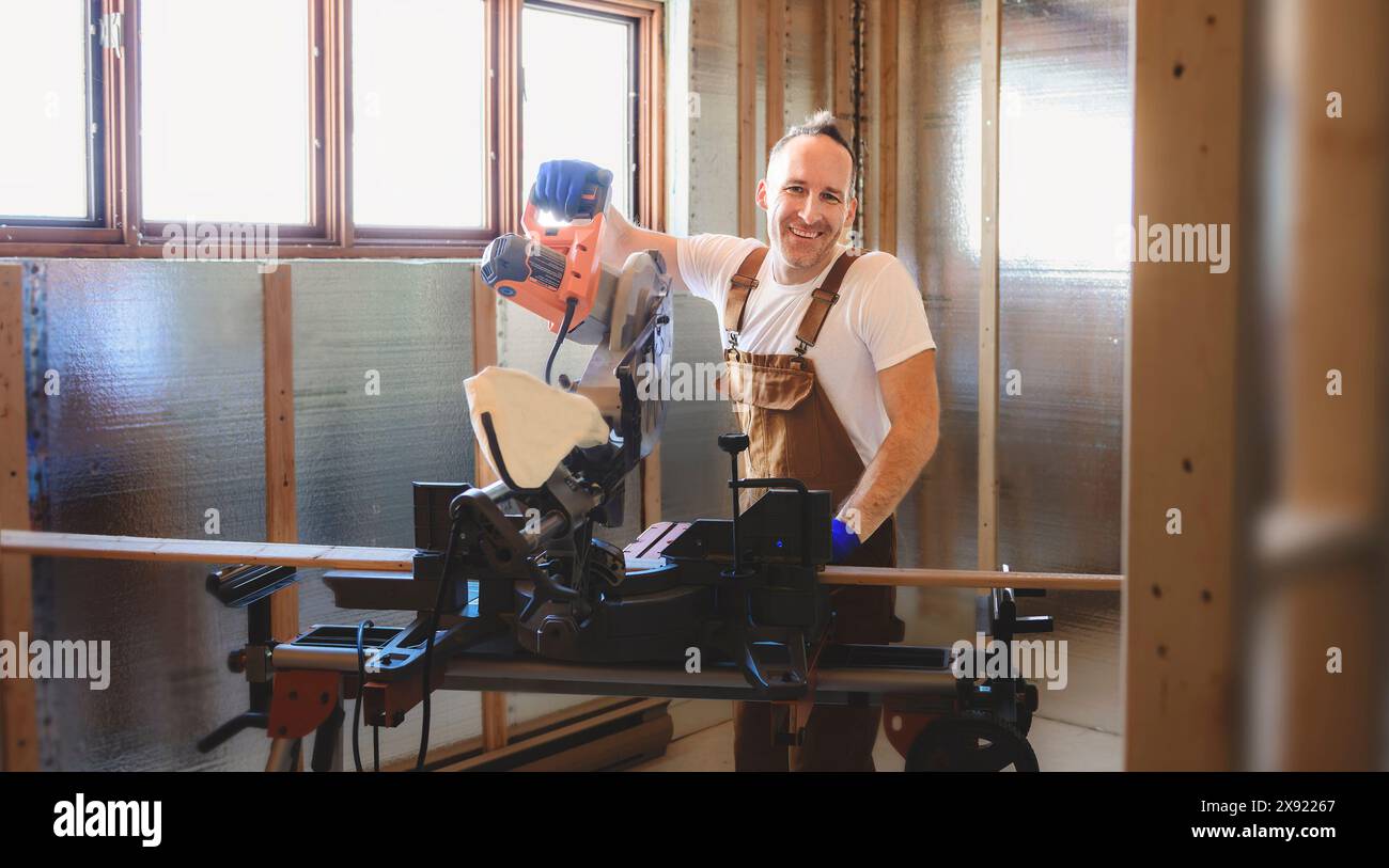 Construction Worker Using Power Tool in Unfinished Basement of New Home ...