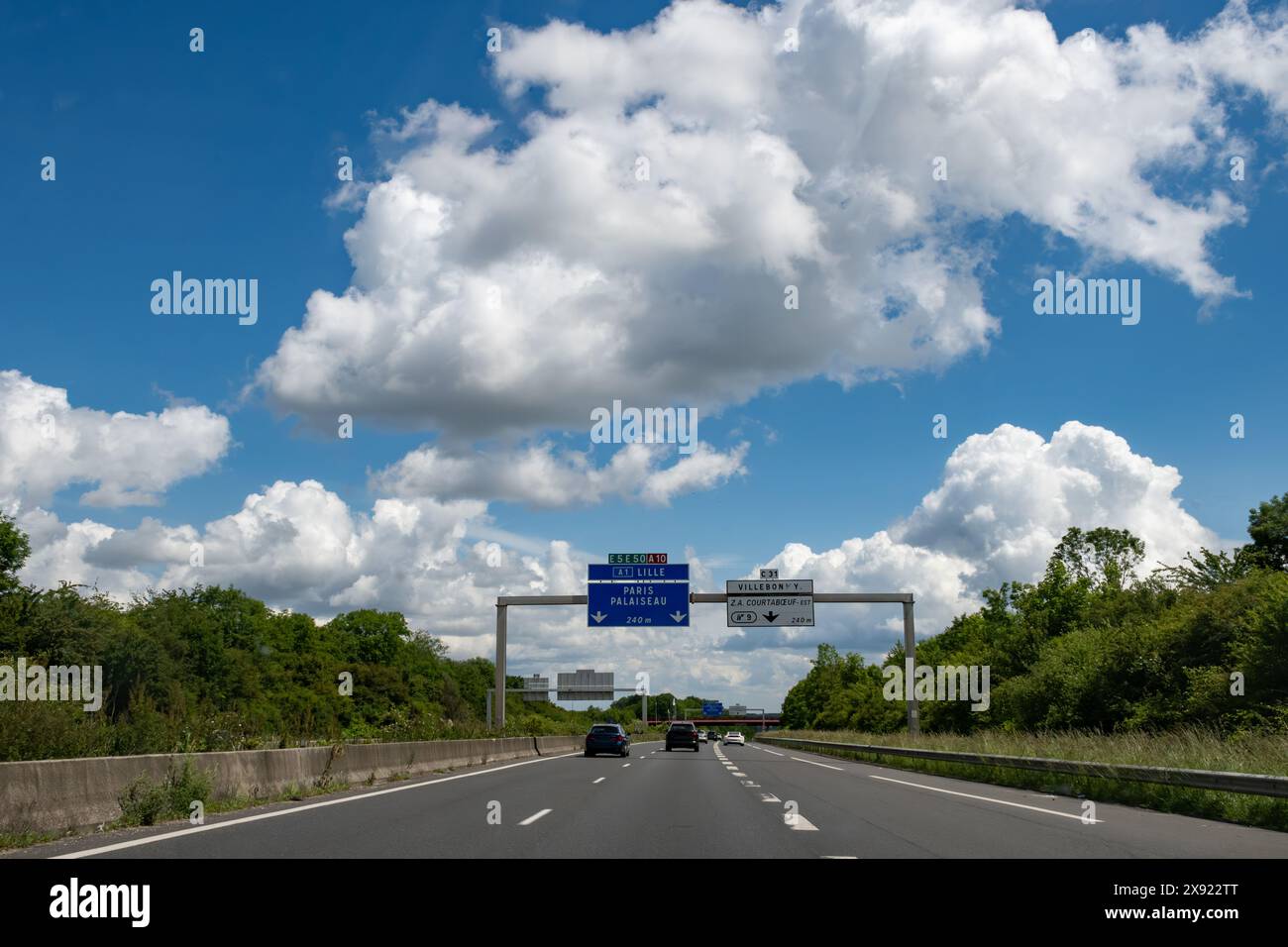 Driving in summer on highway and road signs direction to Paris and ...