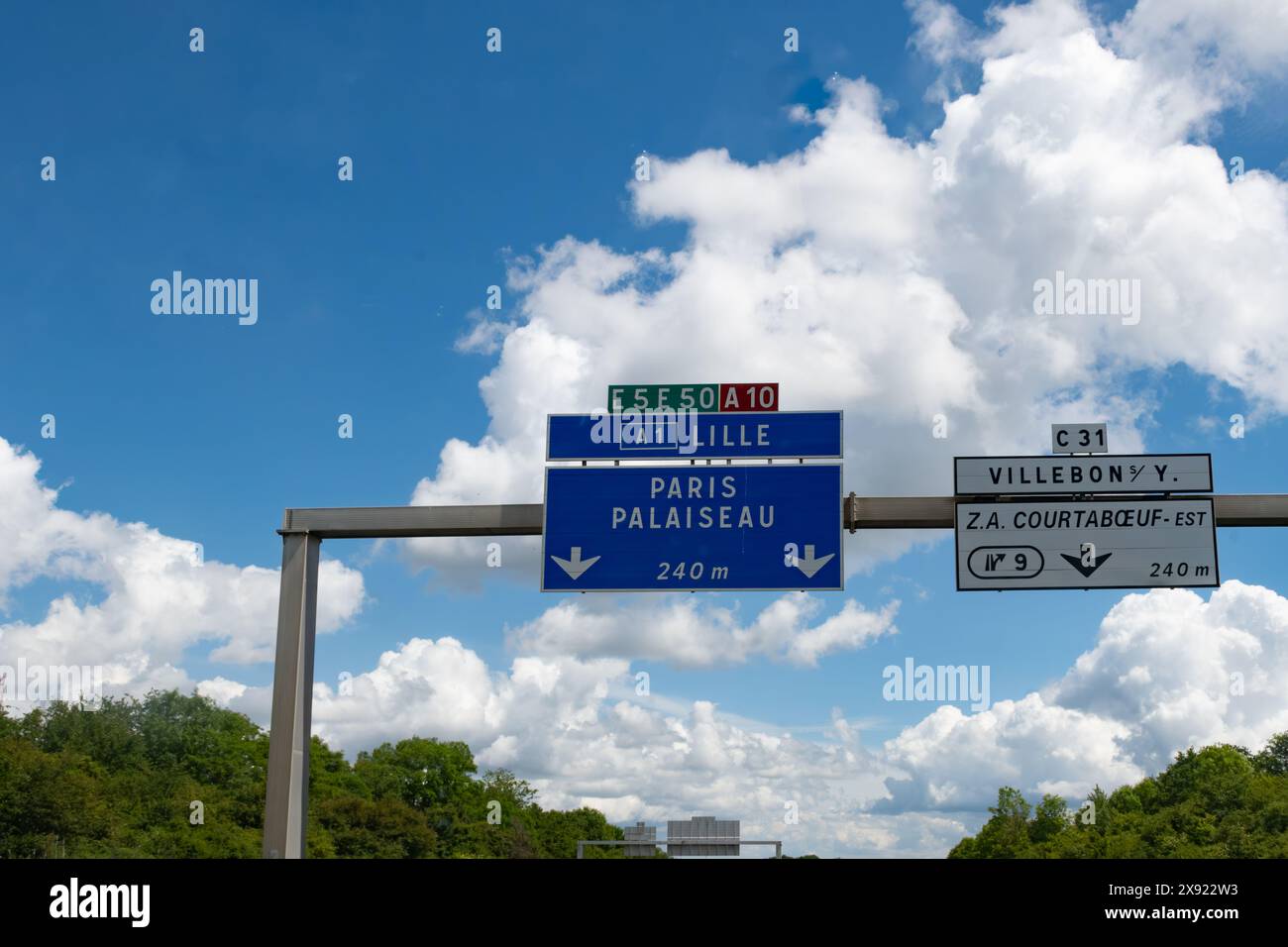 Driving in summer on highway and road signs direction to Paris and ...