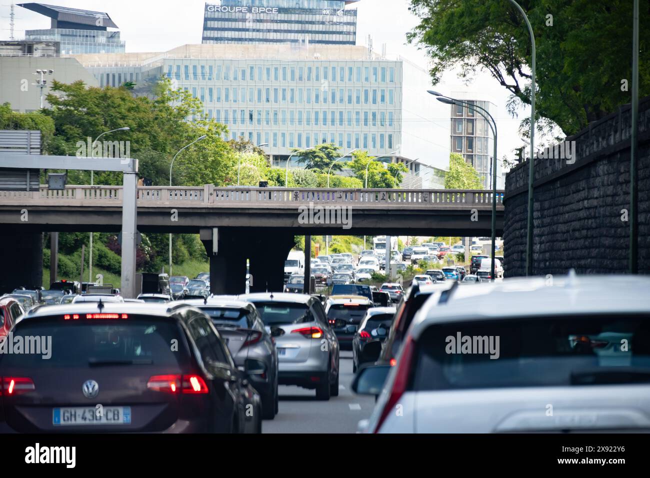 Driving in heavy summer traffic on ring road of capital of France ...
