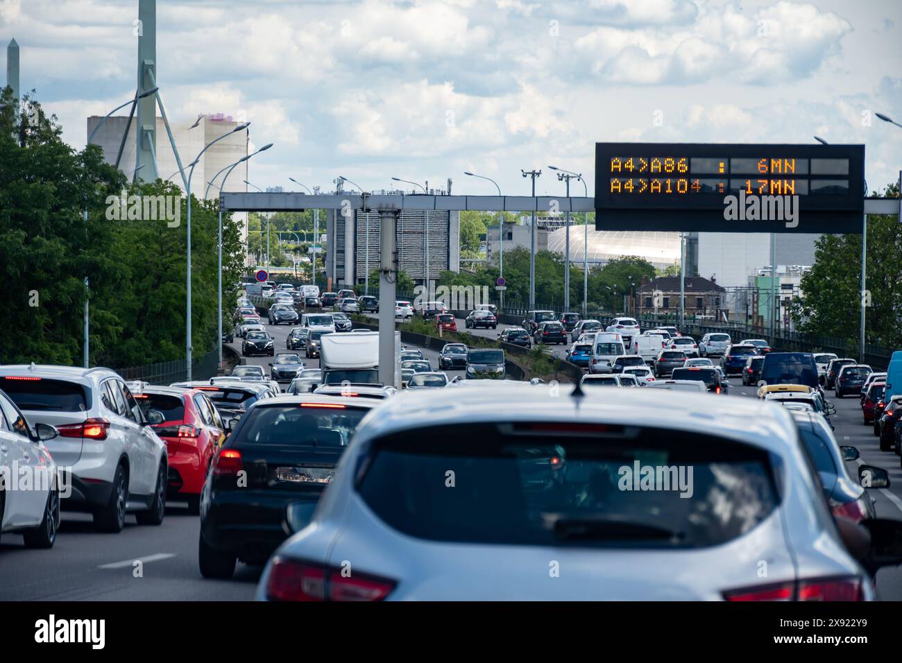 Driving in heavy summer traffic on ring road of capital of France ...