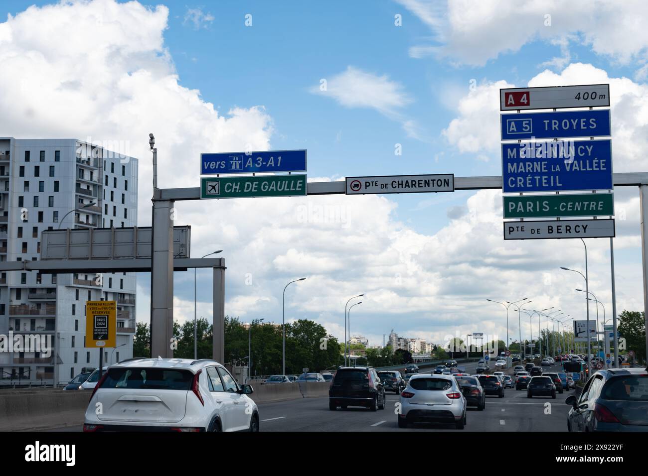 Driving in heavy summer traffic on ring road of capital of France ...