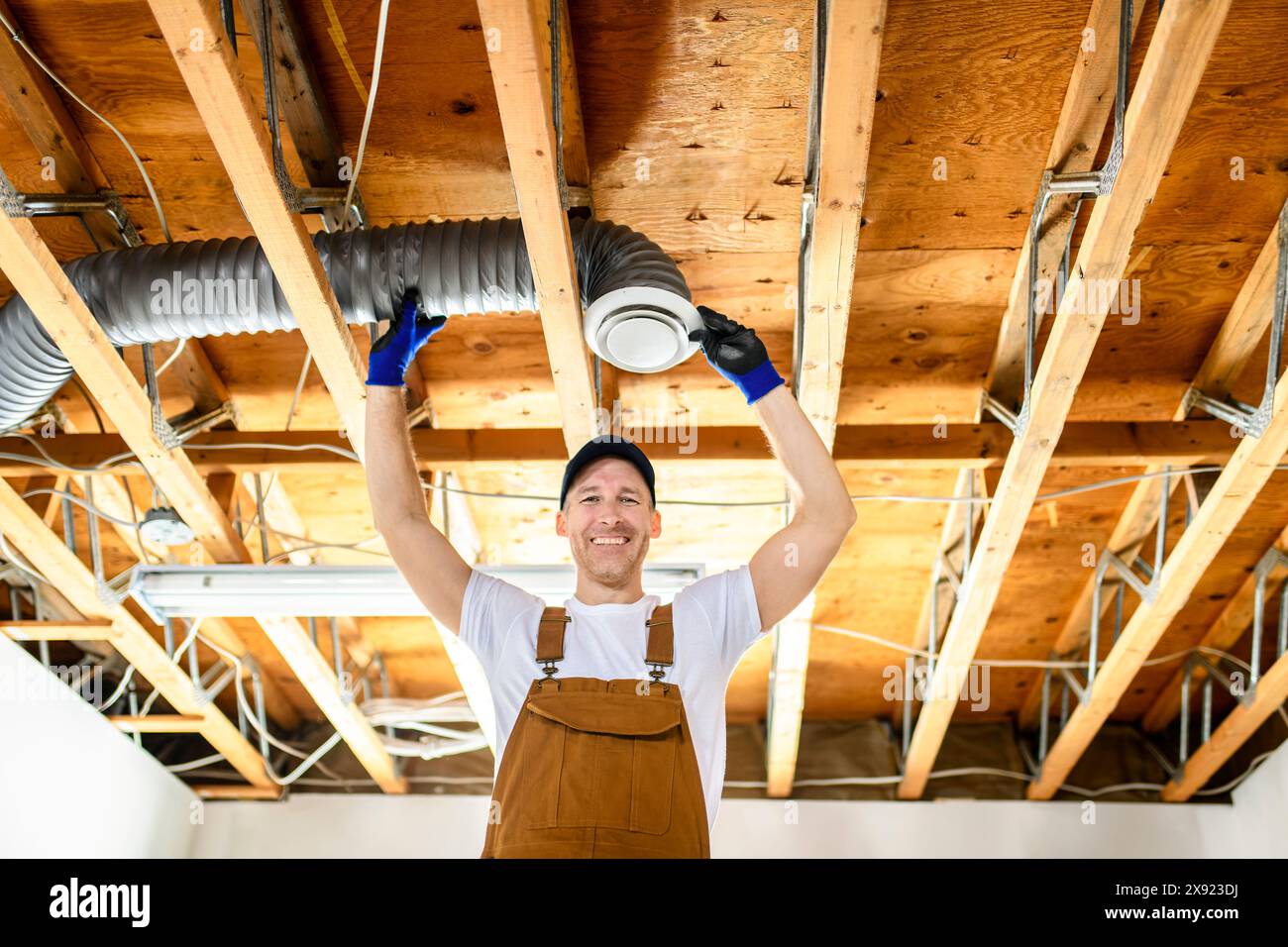 male contractor installing an air conditioning unit Stock Photo - Alamy