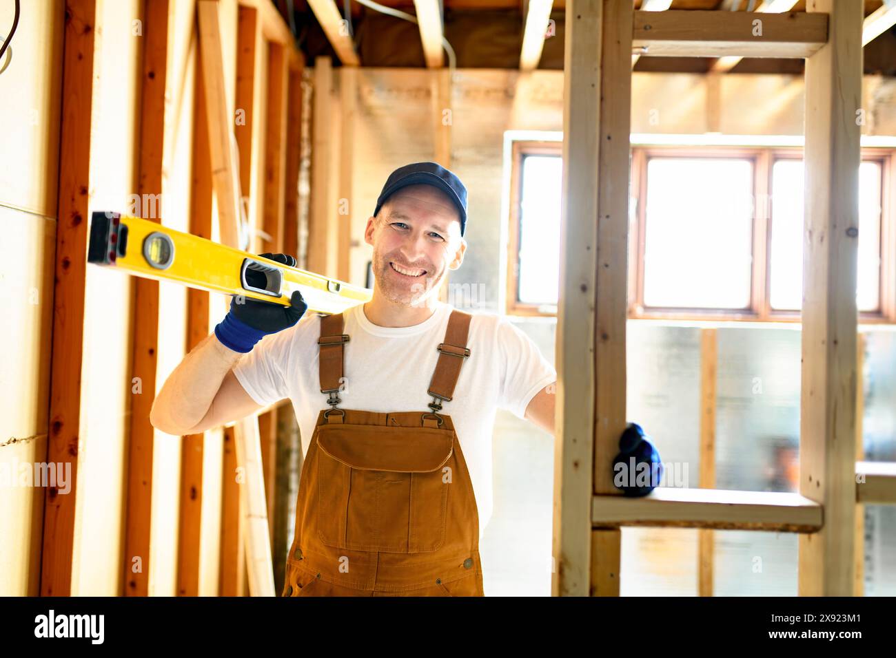 Construction Worker Using Power Tool in Unfinished Basement of New Home ...