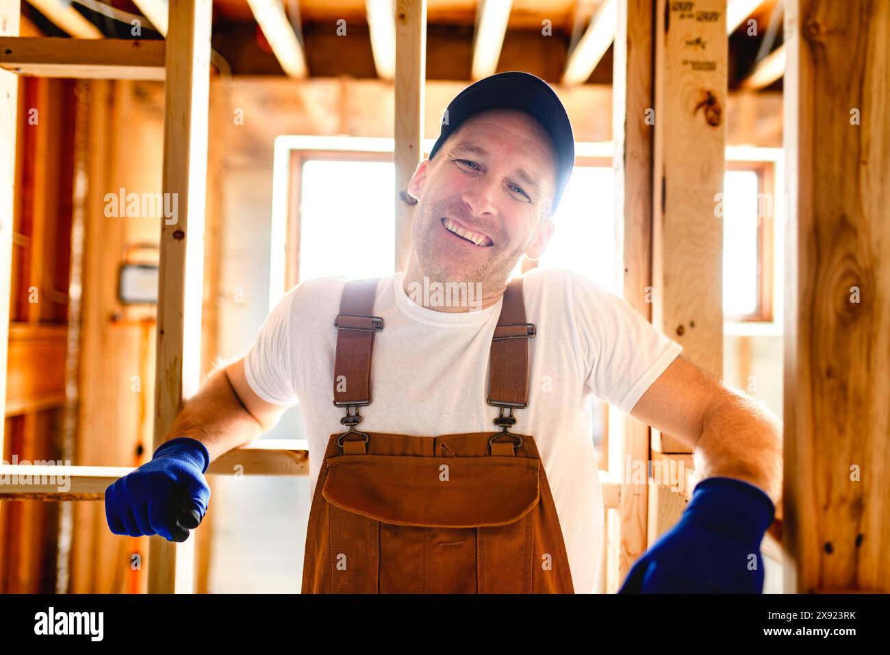 Construction Worker Using Power Tool in Unfinished Basement of New Home ...