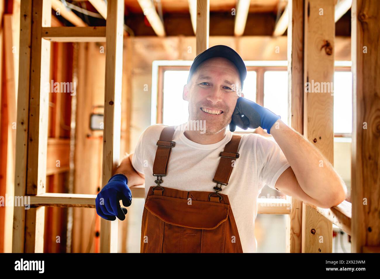 Construction Worker Using Power Tool in Unfinished Basement of New Home ...