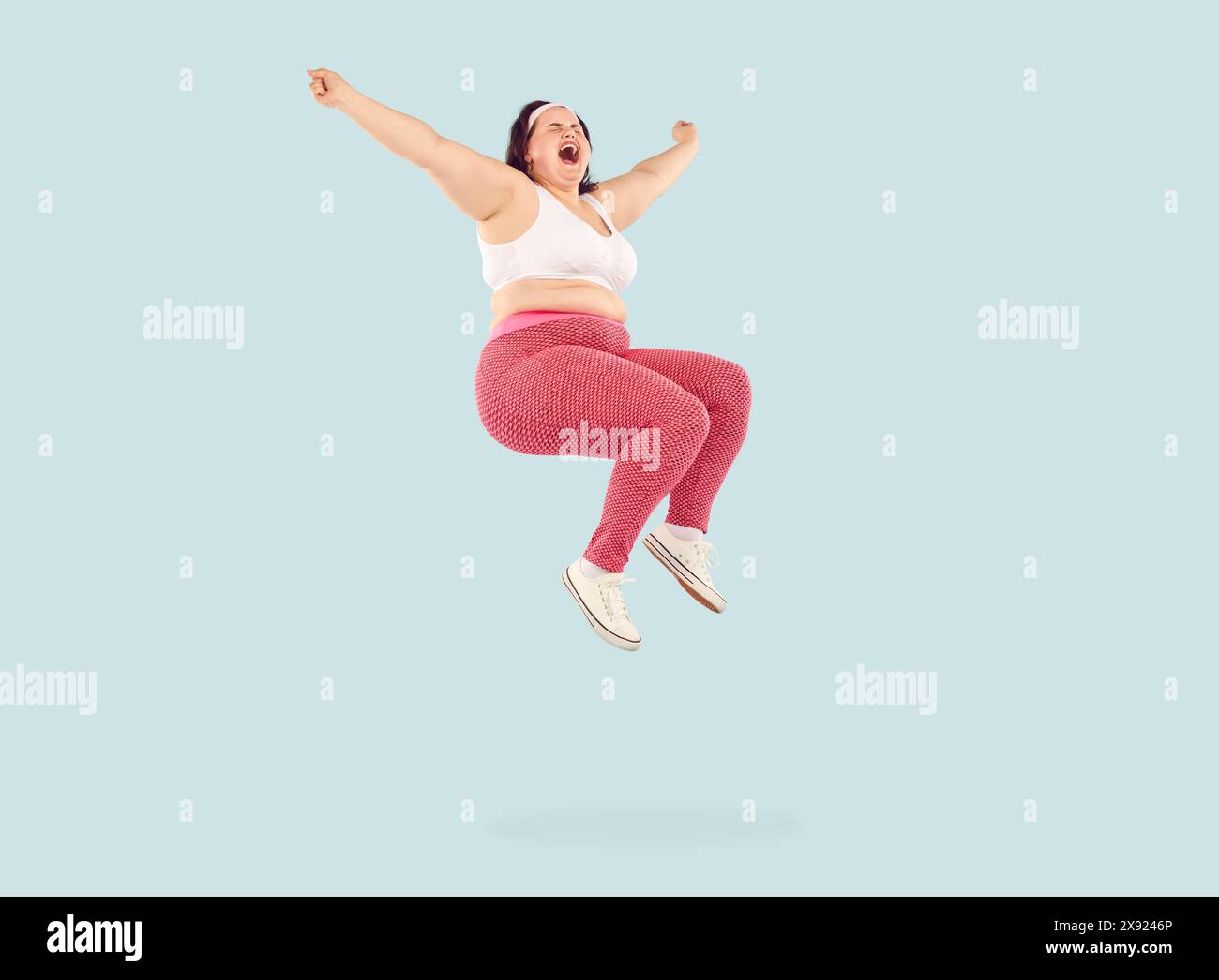 Full length shot of funny chubby overweight woman jumping in air Stock ...