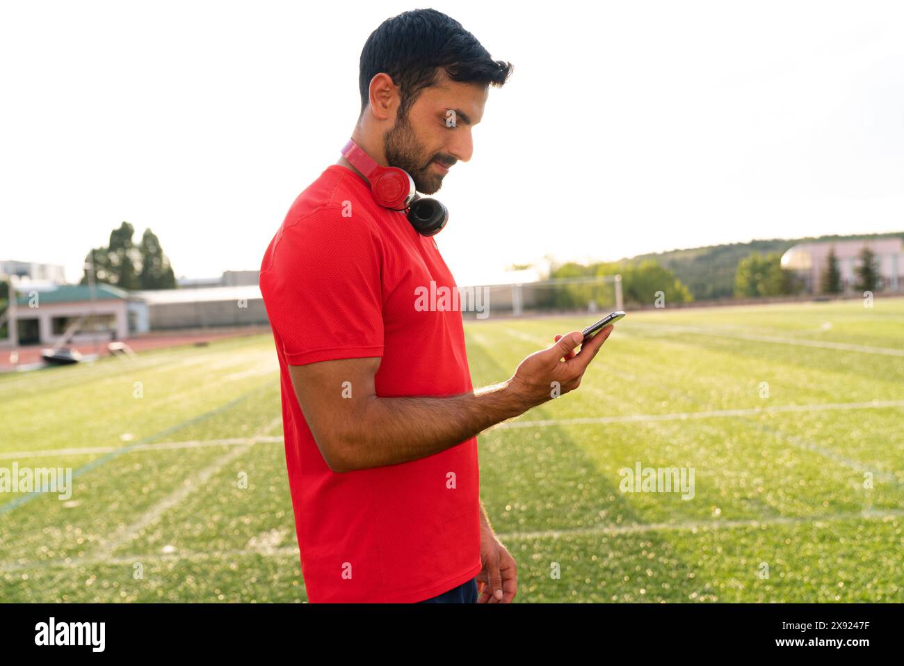 man using smart phone inside city park after exercising outdoor ...