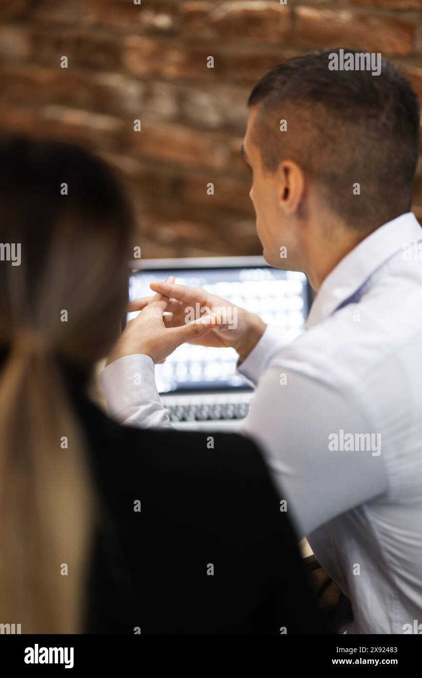 Two professionals engaged in a business meeting in a stylish office ...