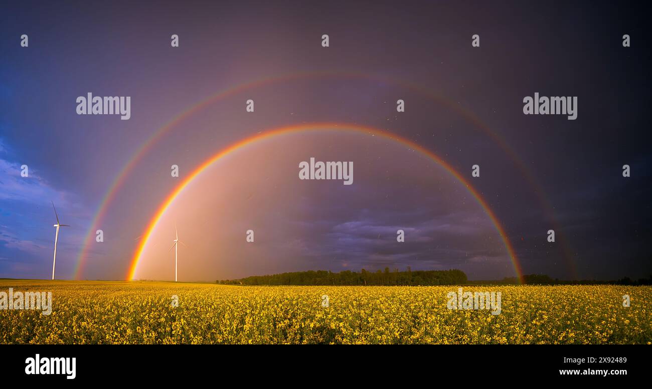 Double rainbow over wind turbines in rural setting focusing on nature ...