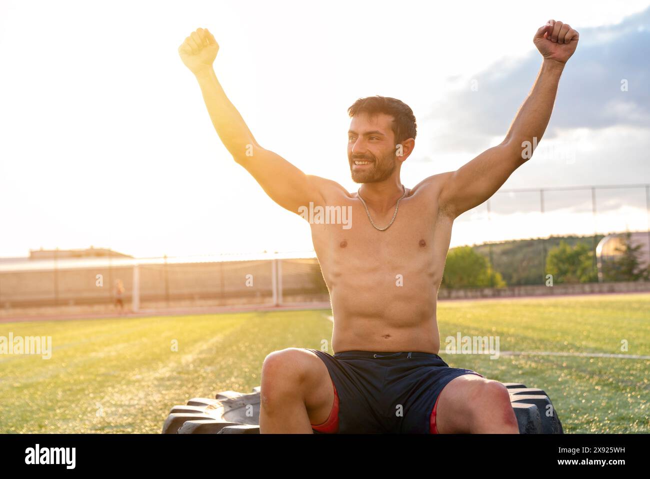 Muscular male athlete celebrating victory with arms in the air Stock ...