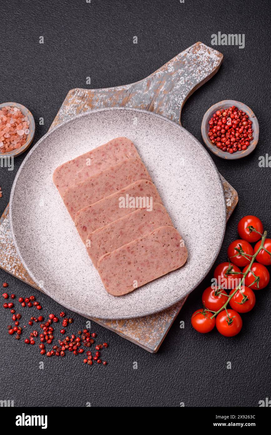 Delicious canned pink ham with salt, spices and herbs on a dark ...