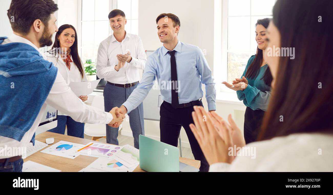 Happy smiling company employees making successful deal in office ...