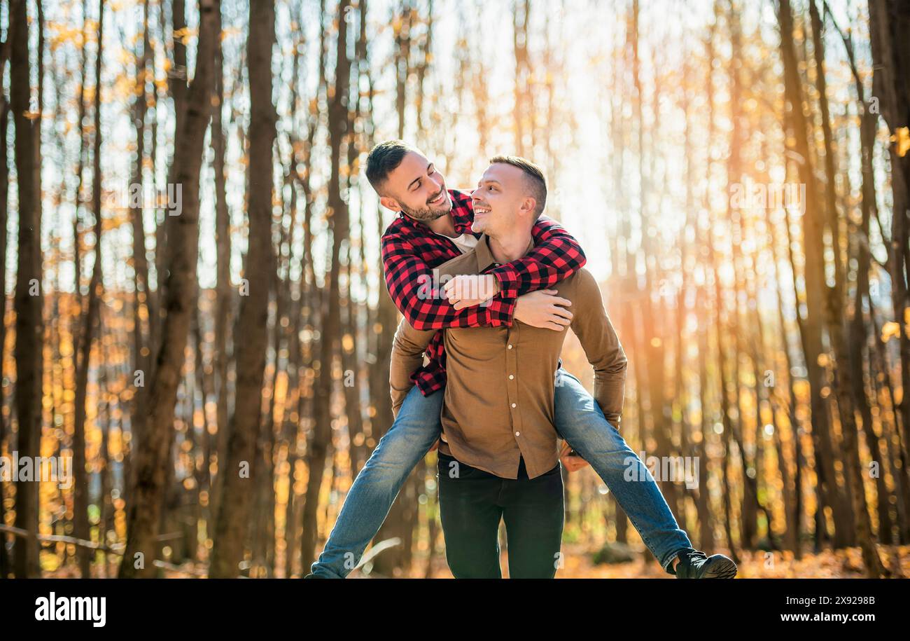 Happy two men couple in autumn park Stock Photo - Alamy