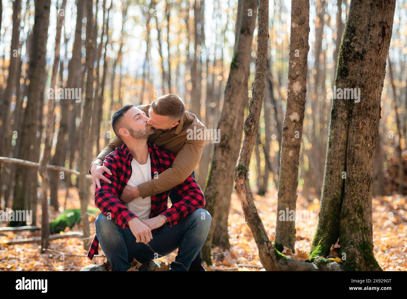 Happy two men couple in autumn park Stock Photo - Alamy
