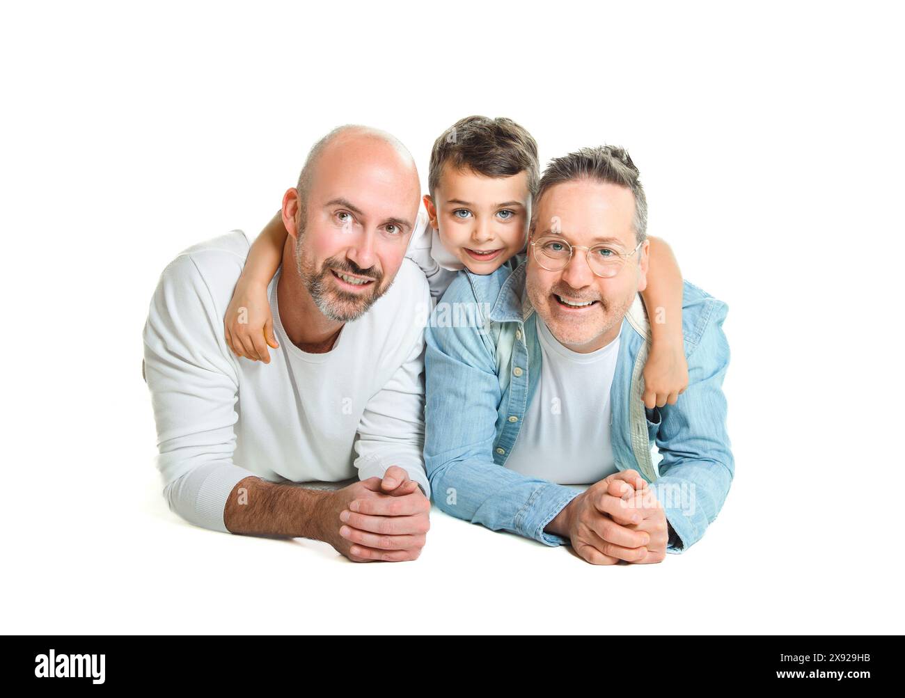 Two man couple with adopted child on white background Stock Photo - Alamy