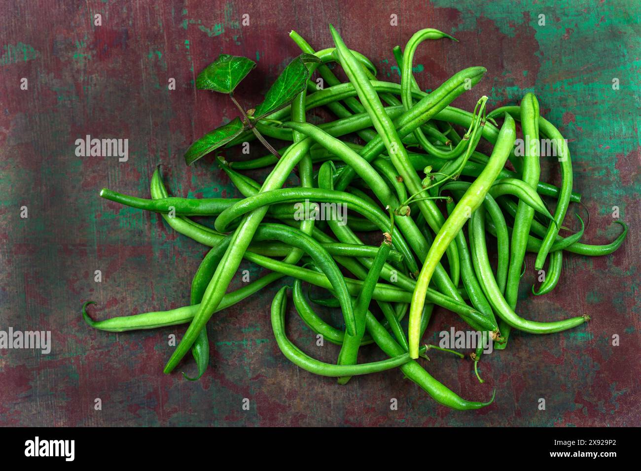 Green beans from the vegetable garden placed on an old brown and green ...