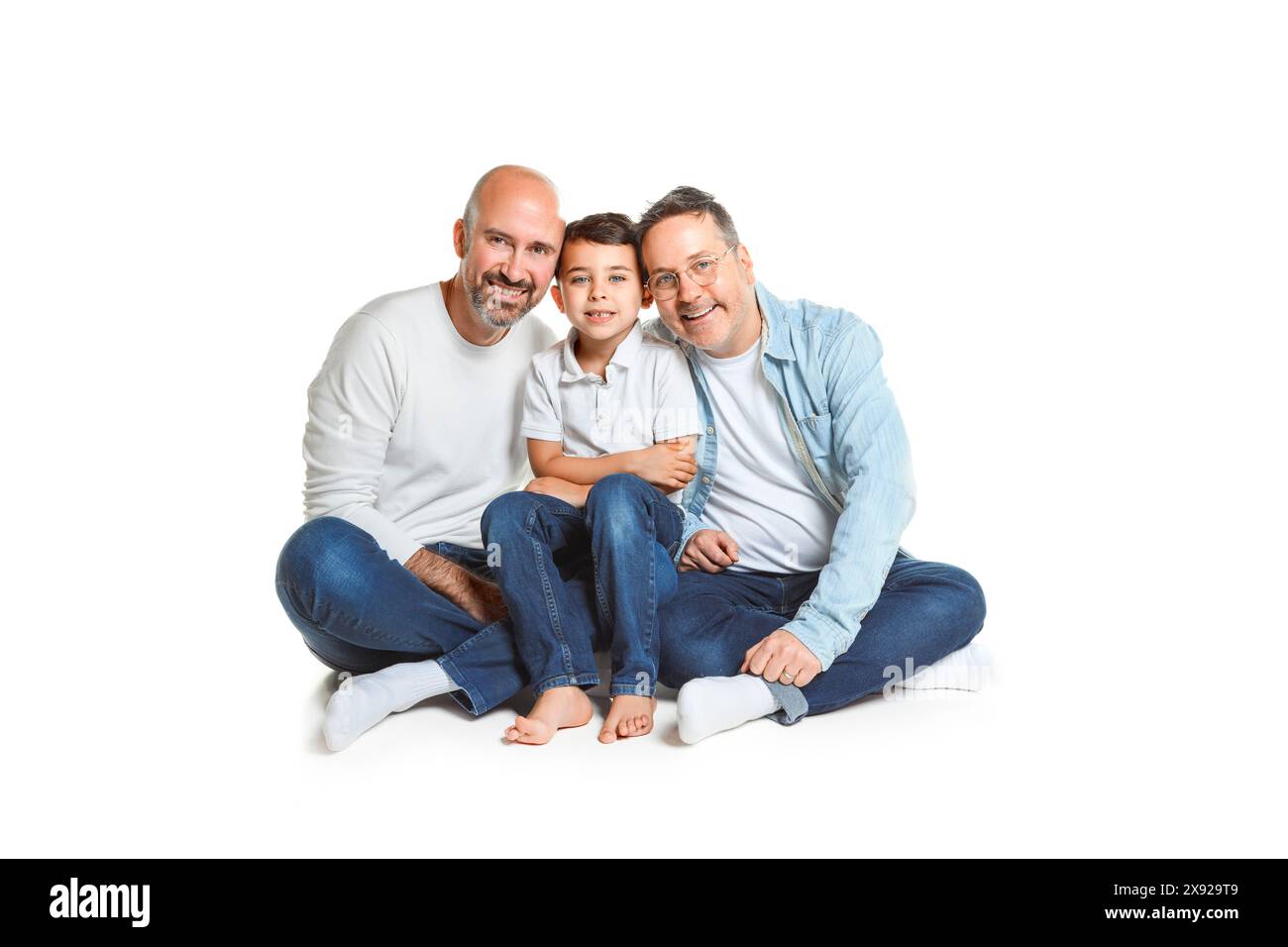 Two man couple with adopted child on white background Stock Photo - Alamy