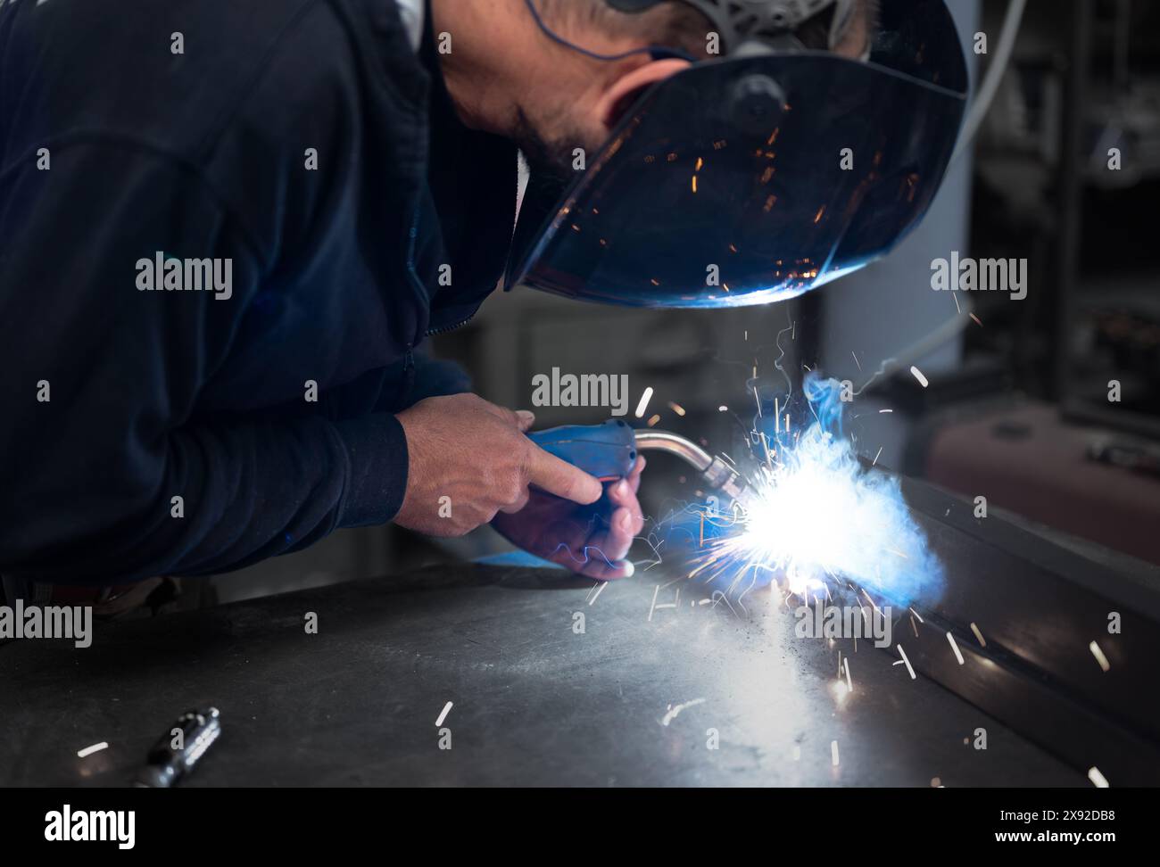 Spectacular conceptual image of a blacksmith busy using the welding ...