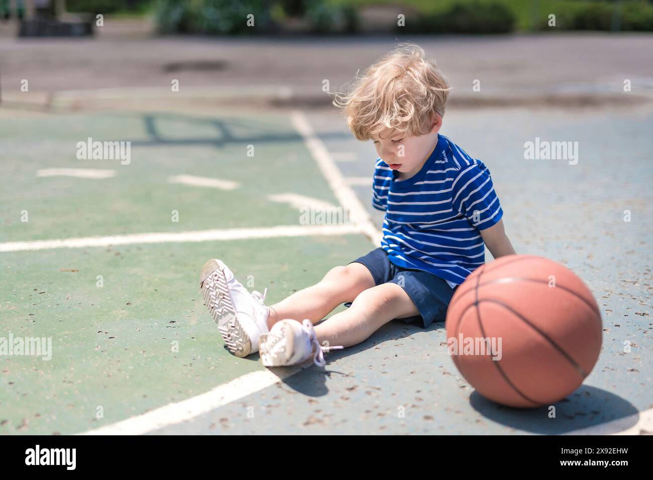 Sports Injury. child boy with knee trauma after playing basketball ...