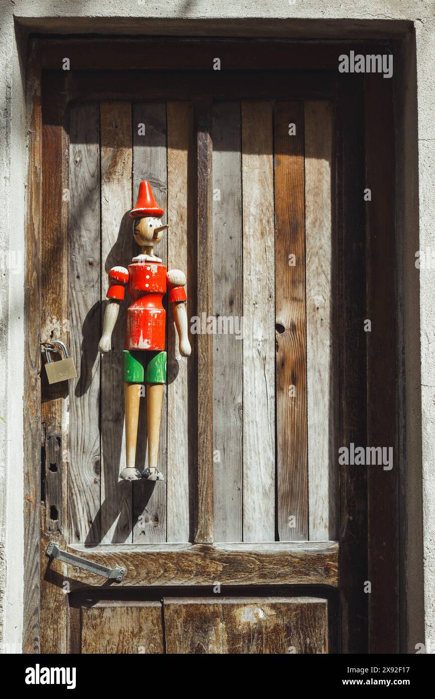 A small toy puppet Pinocchio in the historic Italian town of Collodi ...