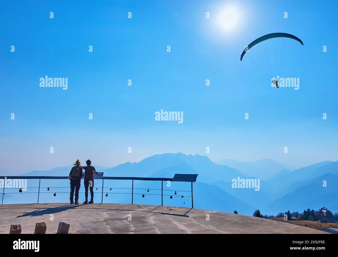 The glider aircraft over Cardada Cimetta summit with hazy mountains in ...